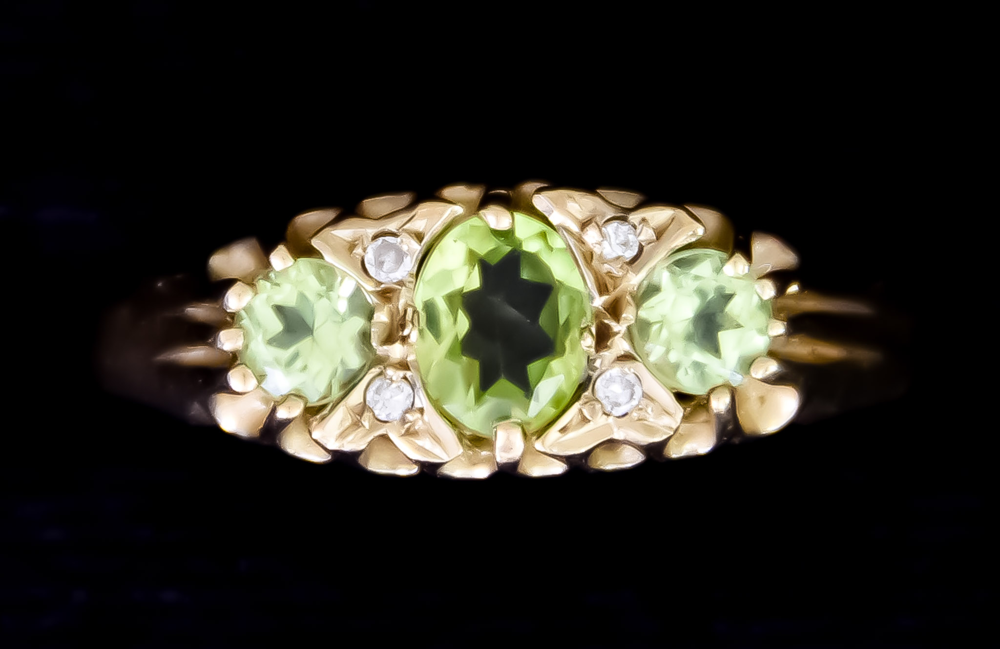 A 9ct Gold Three Stone Peridot Ring, set with three faceted peridot ...