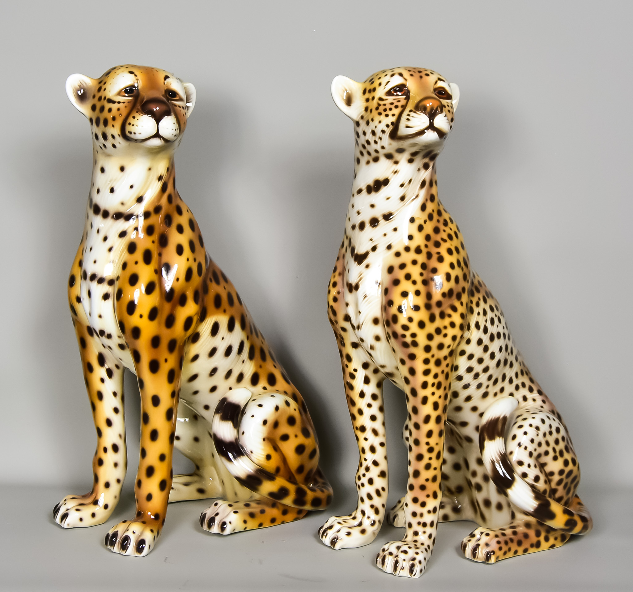 A Pair of Italian Seated Ceramic Cheetahs, 20th Century, stamped to ...