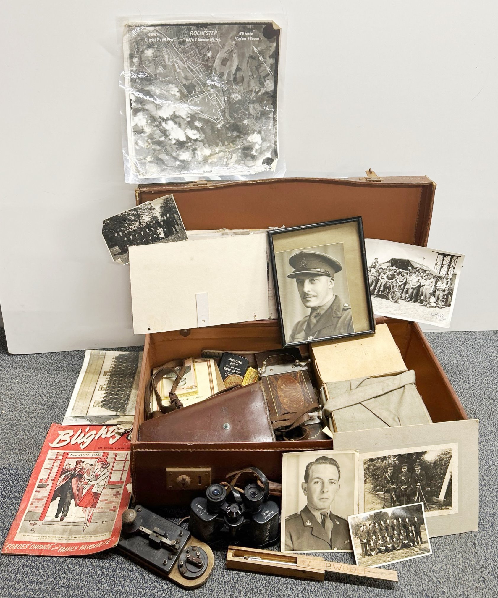 An extensive case of war time militaria including photographs ...