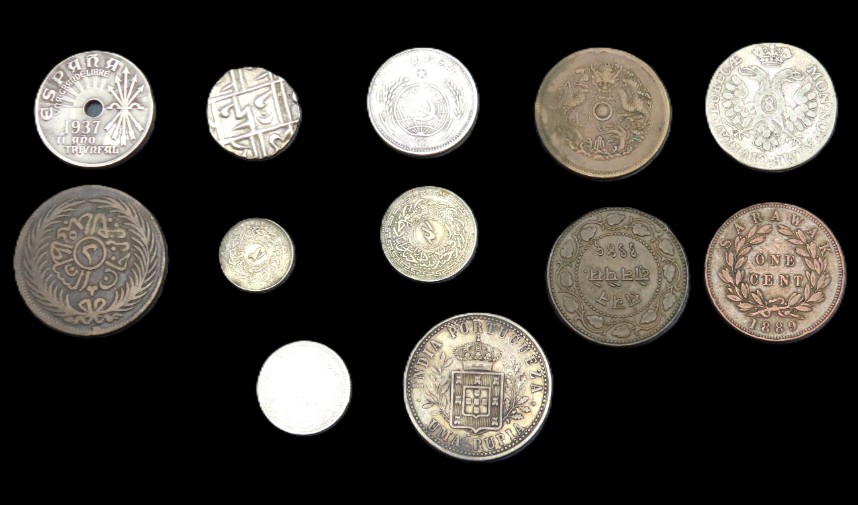 A German 1732 Lubeck silver shilling, an 1889 Sarawak one cent, a ...
