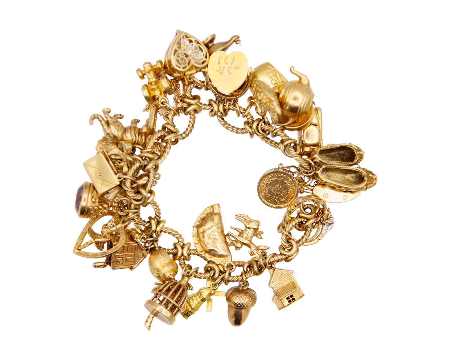 A 9k charm bracelet applied with a good selection of 9k and gold charms ...