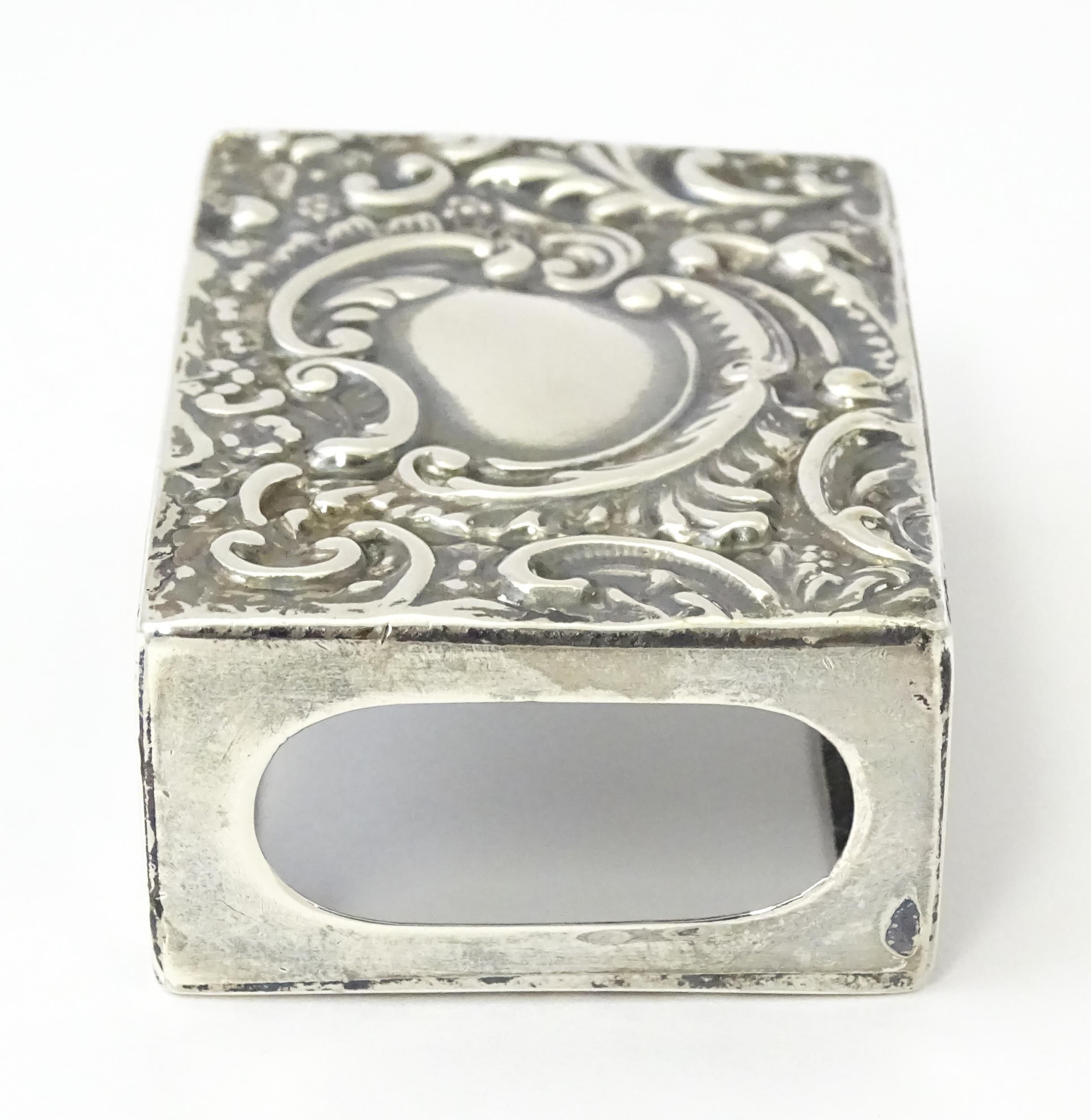 A silver match box cover with embossed decoration, hallmarked Chester ...