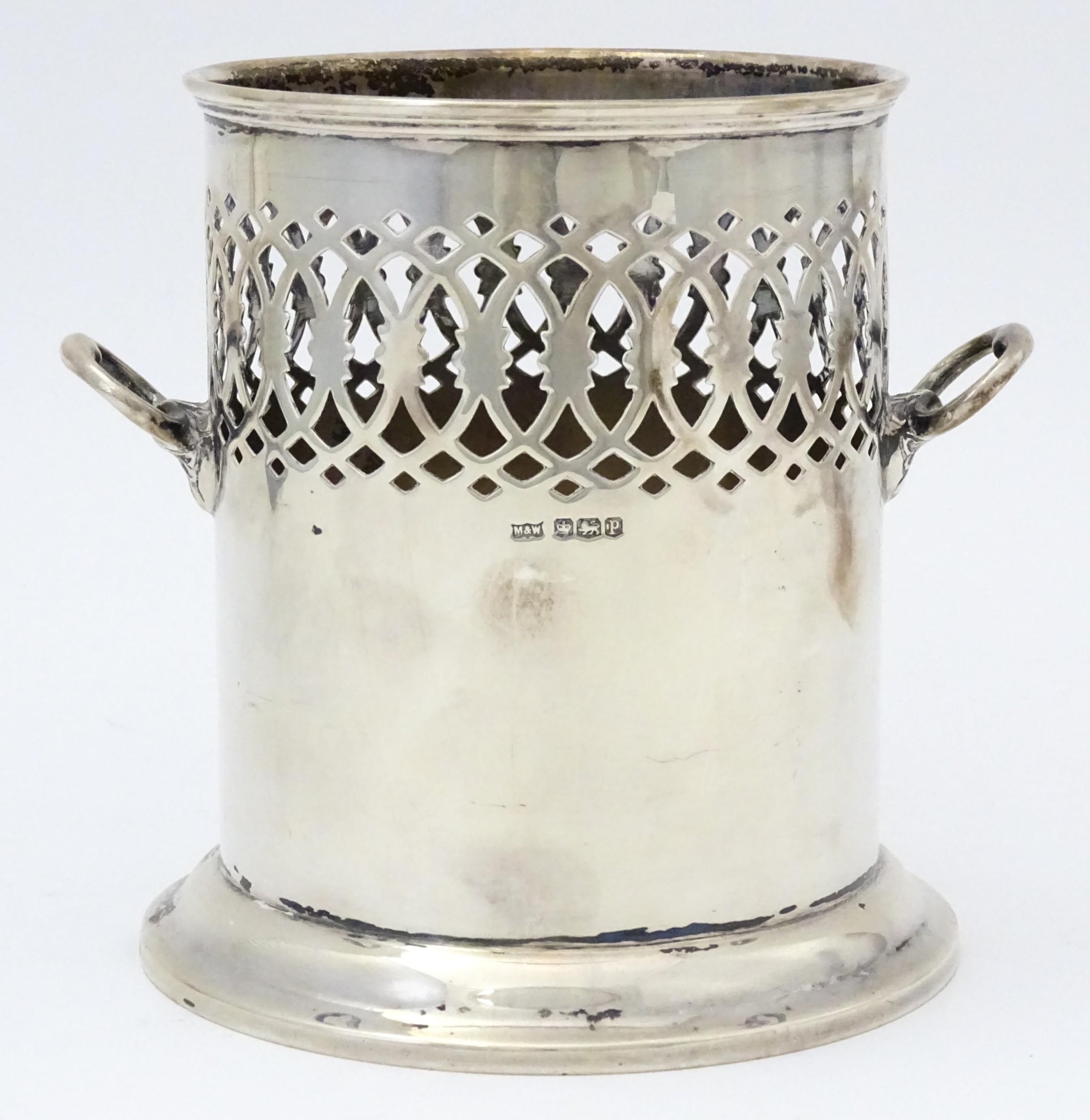 A silver syphon stand / bottle stand with pierced openwork decoration ...