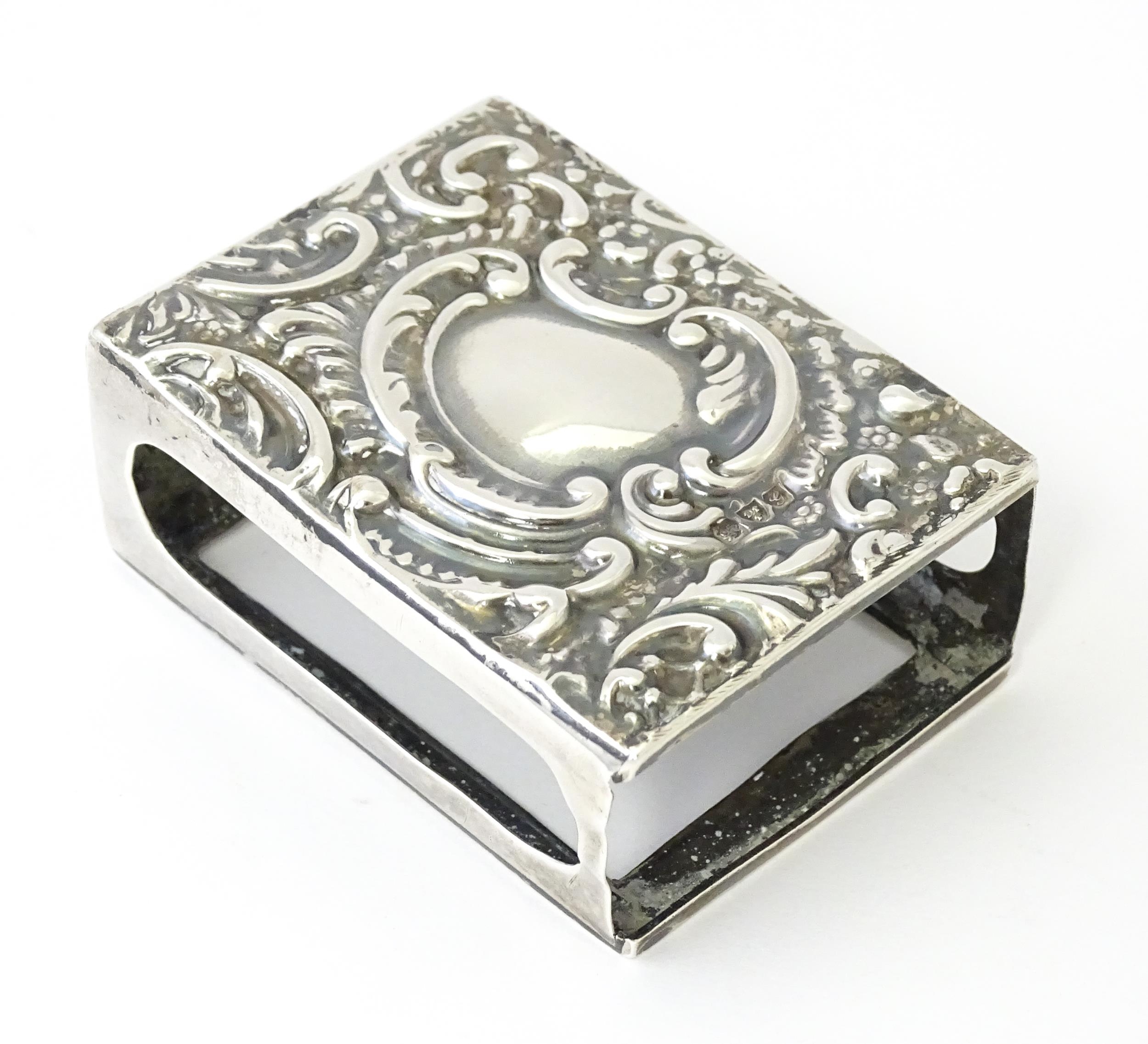 A silver match box cover with embossed decoration, hallmarked Chester ...