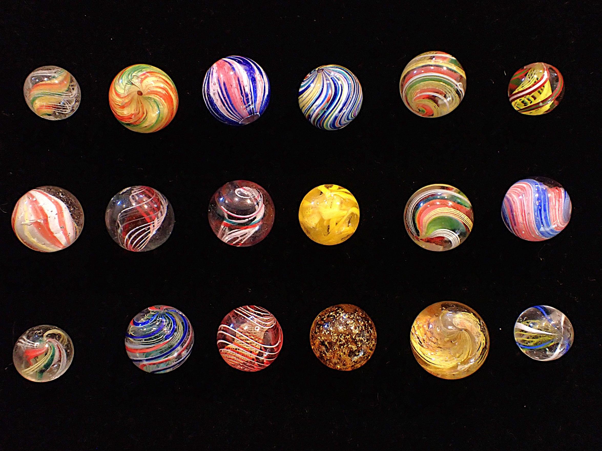 A COLLECTION OF ANTIQUE GLASS MARBLES one with 'gold' flecks, some with ...