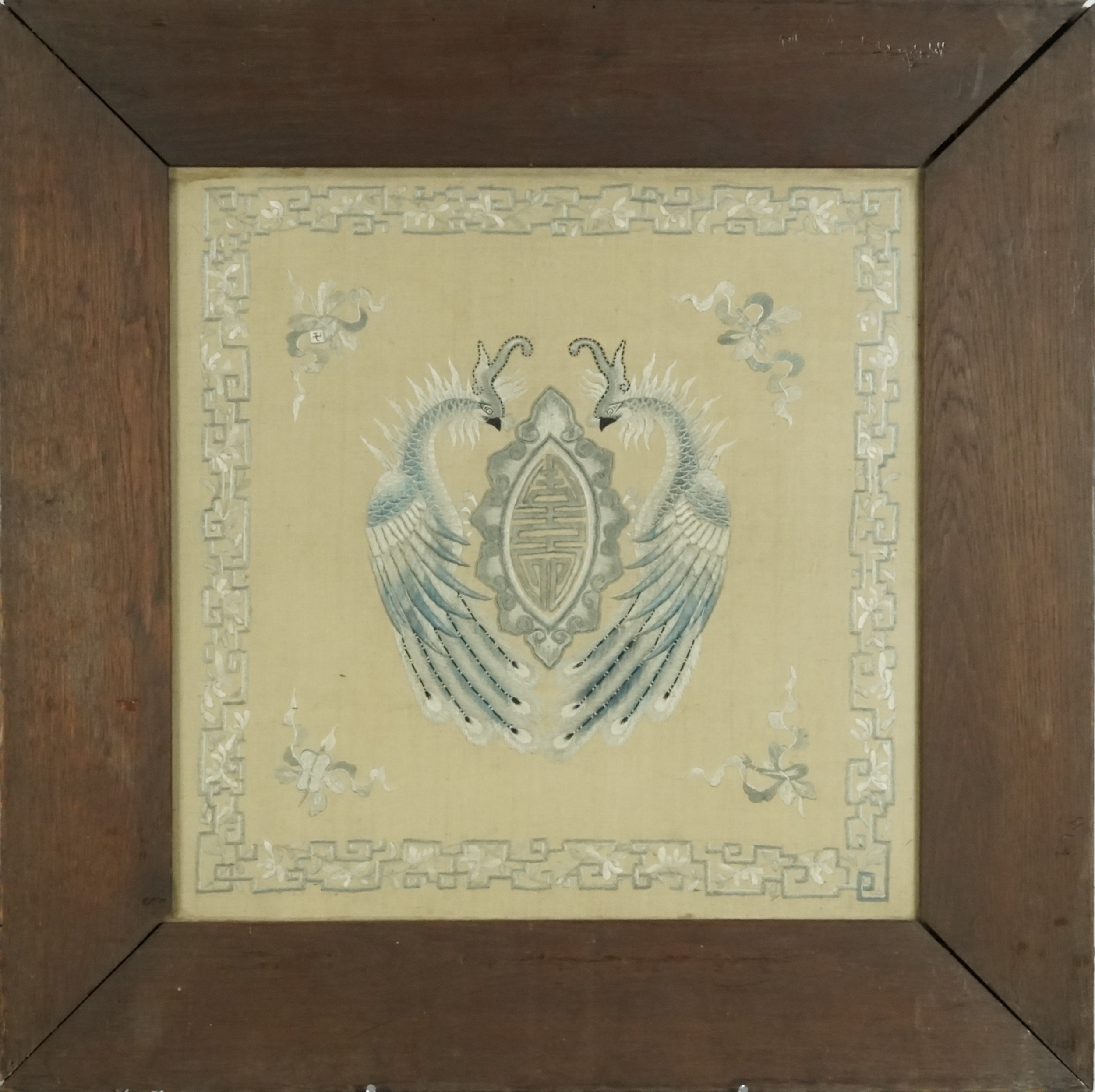 A Chinese silk embroidered rectangular panel with two phoenixes, early 20th century, within a sta