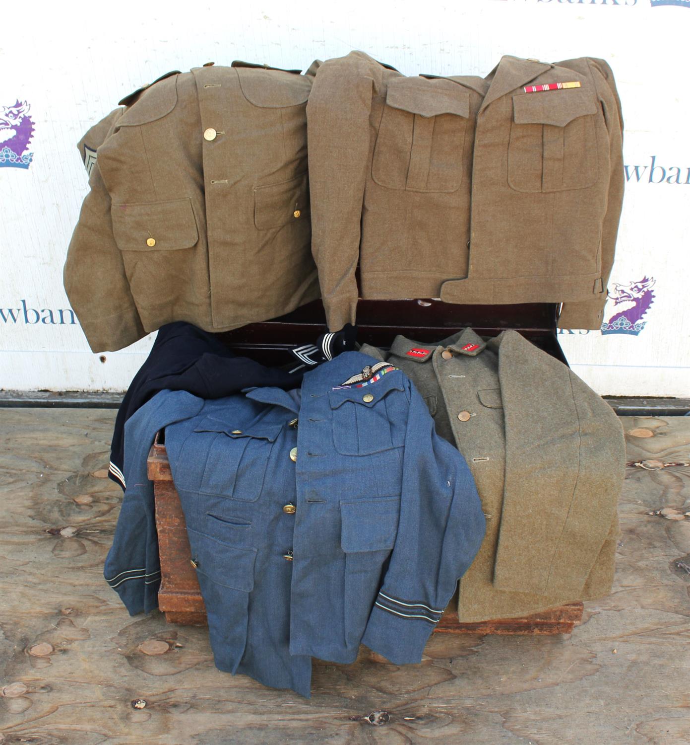 A quantity of military uniforms including R.A.F. contained in a brown ...