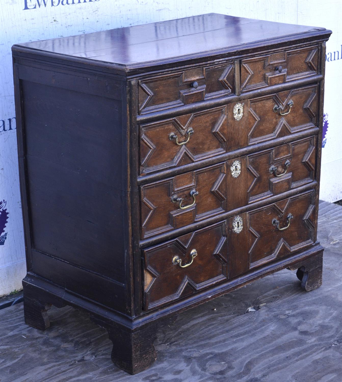 A Queen Anne oak chest of drawers, early 18th century, the twin plank ...