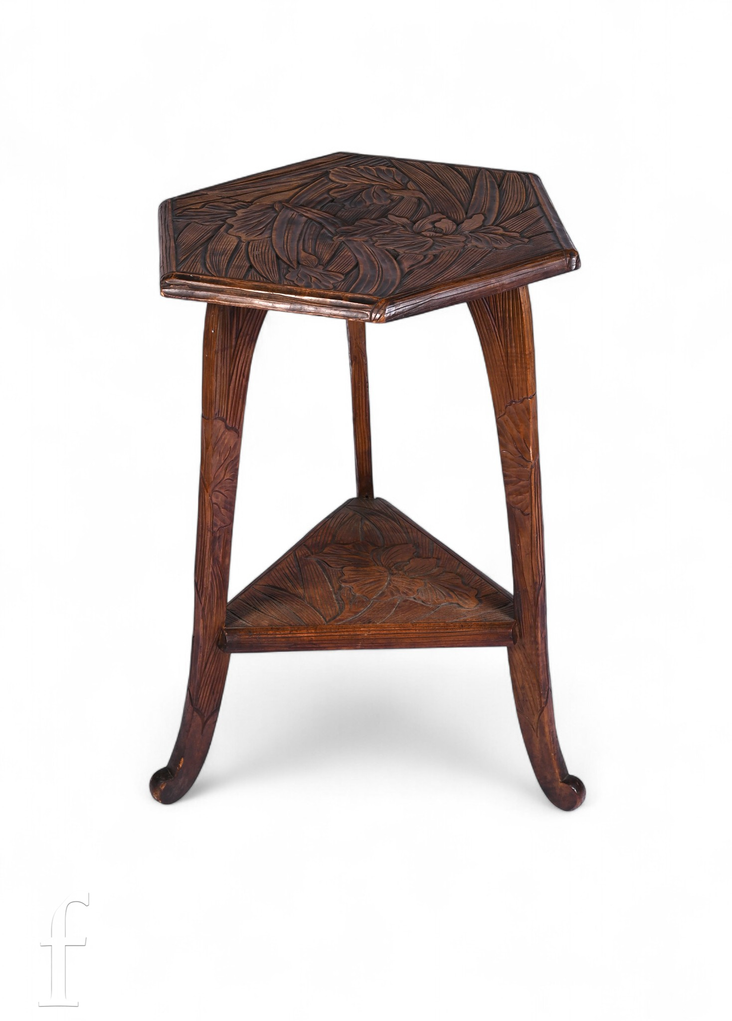 Attributed to Liberty & Co - A carved softwood occasional table of ...