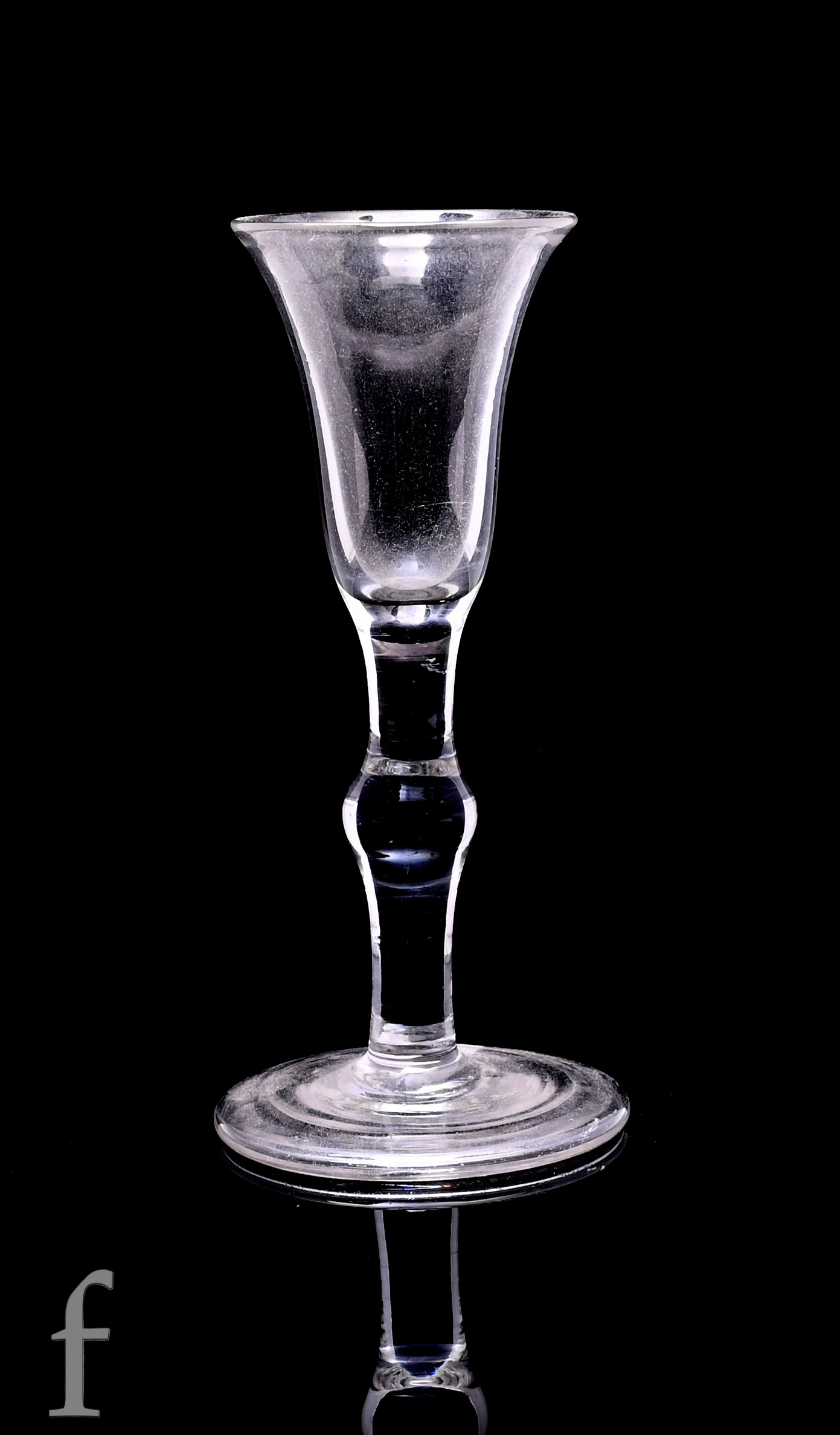 A small 18th Century gin glass circa 1730, the slender bell bowl above ...