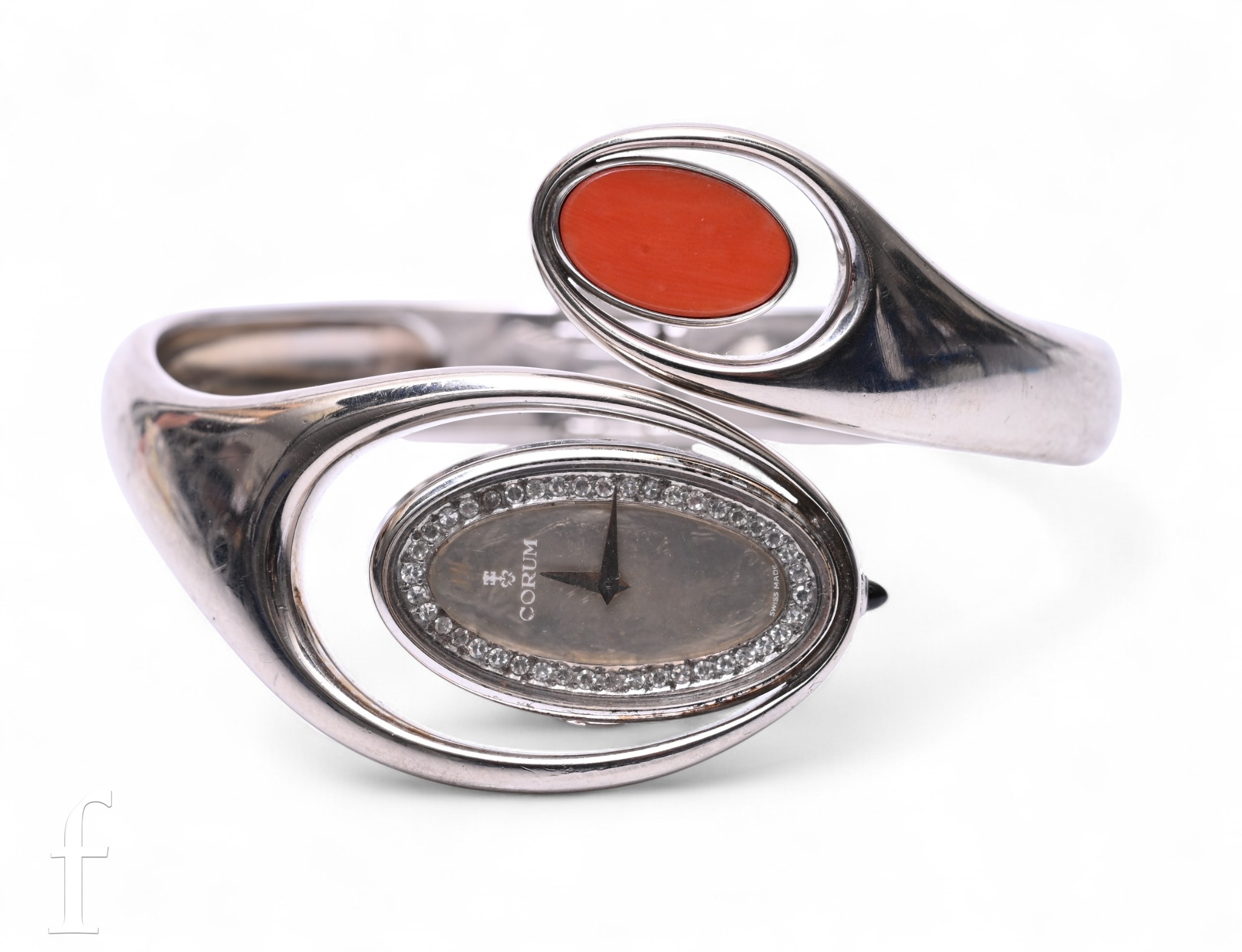 A lady's 18ct white gold Corum bangle watch circa 1980, the oval mother ...