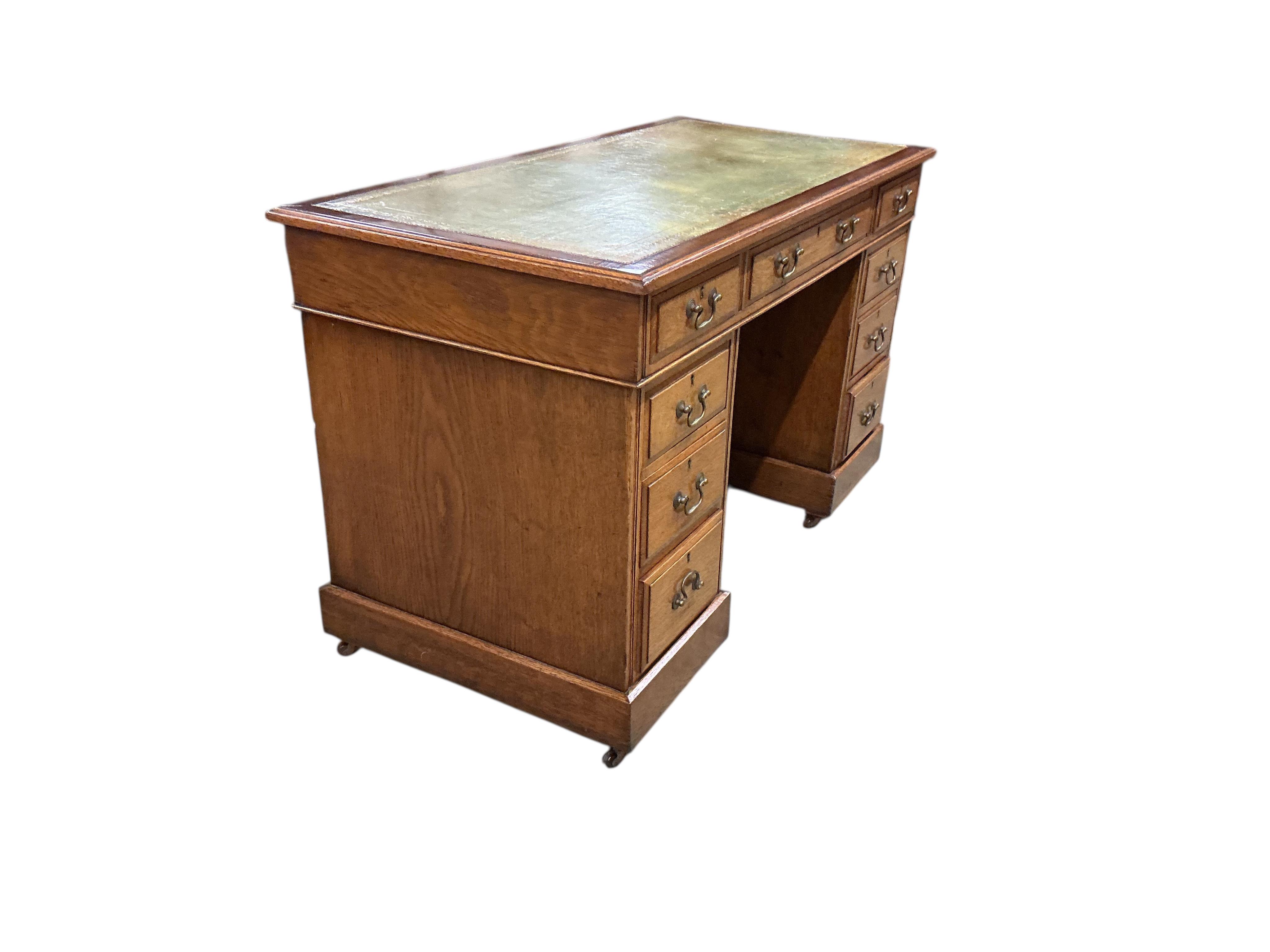 An early 20th century oak pedestal desk, width 122cm, depth 60cm ...