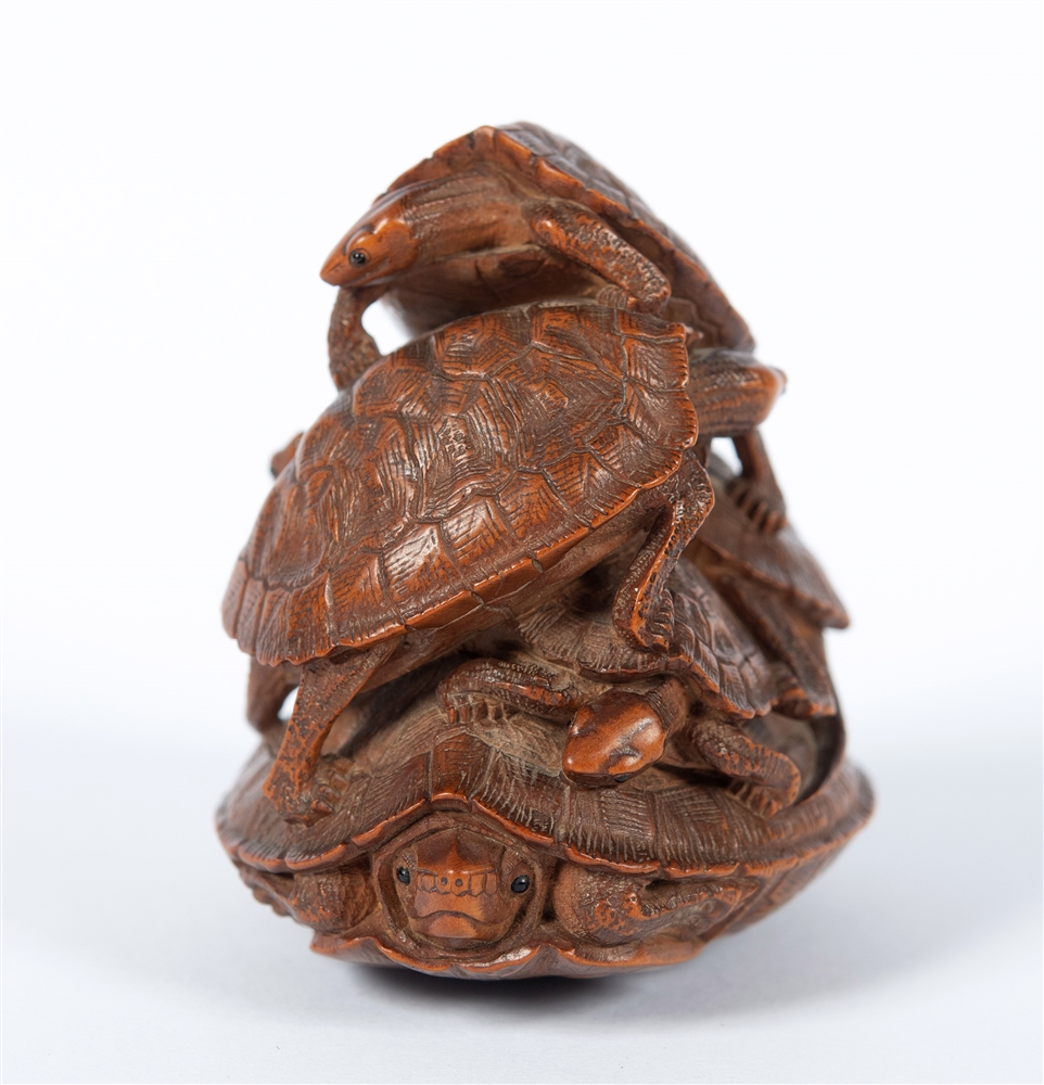 A JAPANESE CARVED WOOD NETSUKE Meiji period, in the form of a female ...
