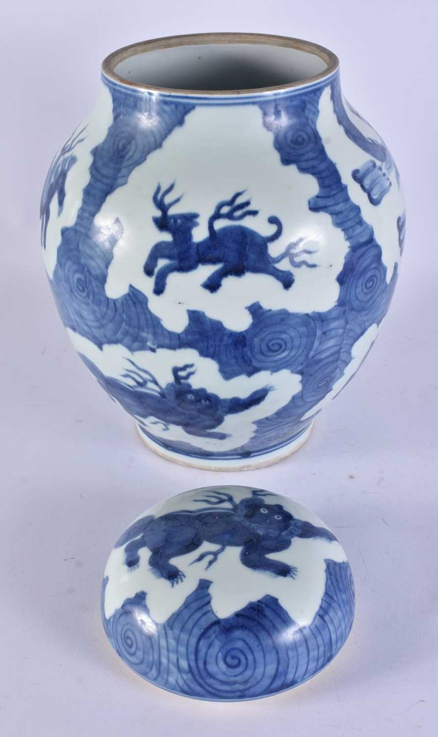 A LARGE CHINESE BLUE AND WHITE JAR AND COVER painted with beasts. 33 cm ...