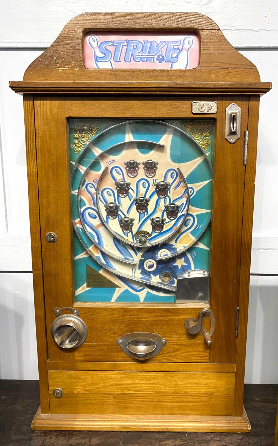 A vintage flip ball arcade machine 'Strike' 2p play, fruitwood case ...