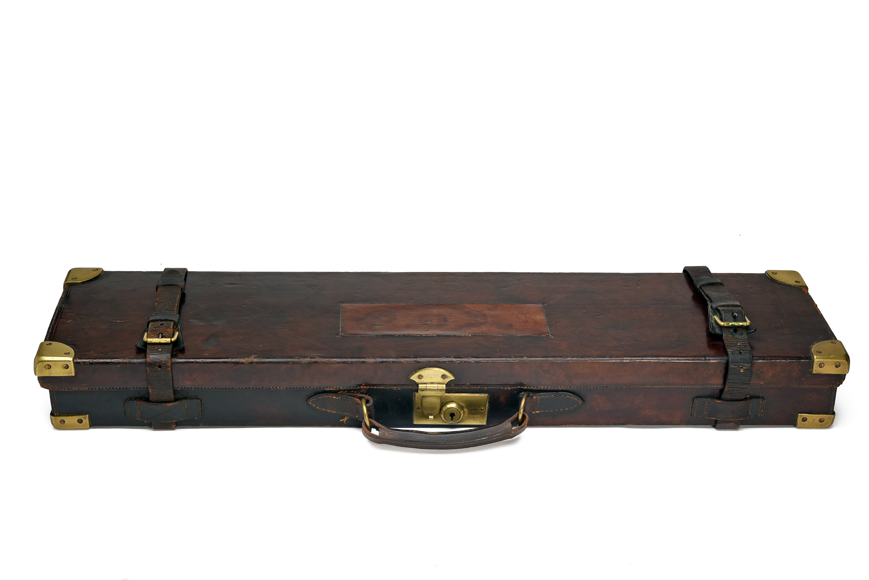 A BRASS-CORNERED LEATHER SINGLE GUNCASE, fitted for 30in. barrels, the ...