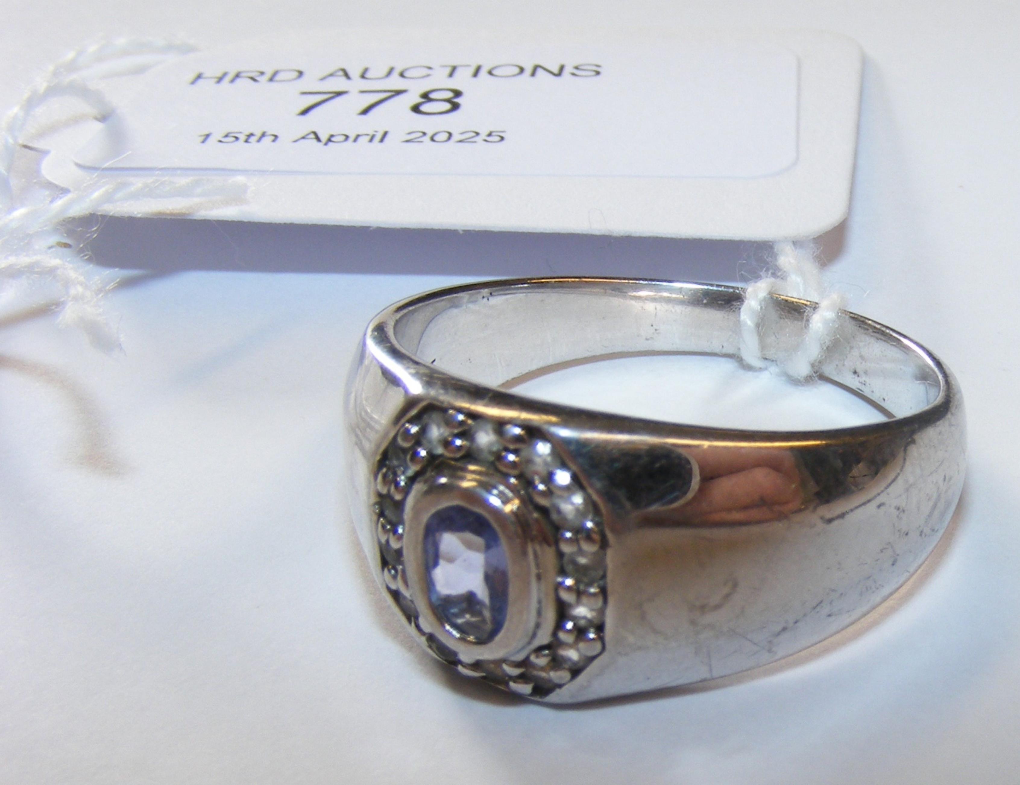 A designer pale blue stone dress ring in silver setting