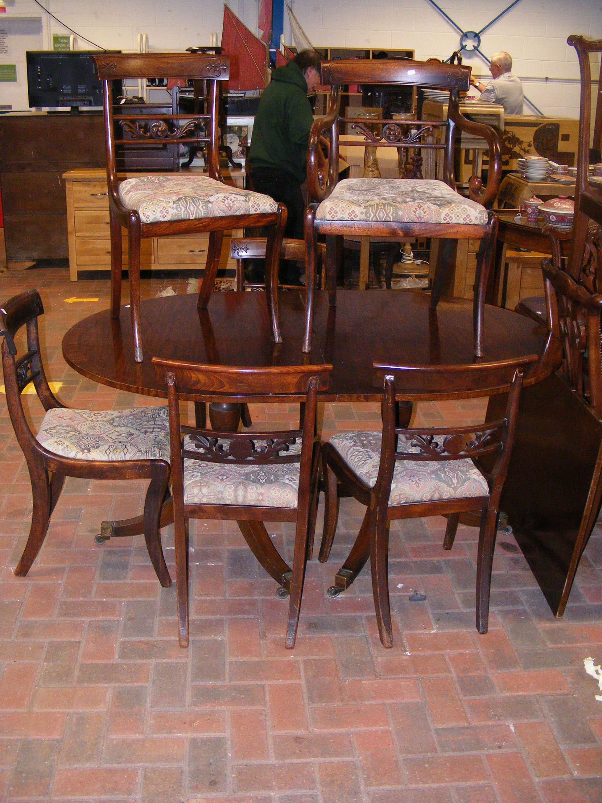 A mahogany extending dining table, together with seven chairs (6 plus 1)