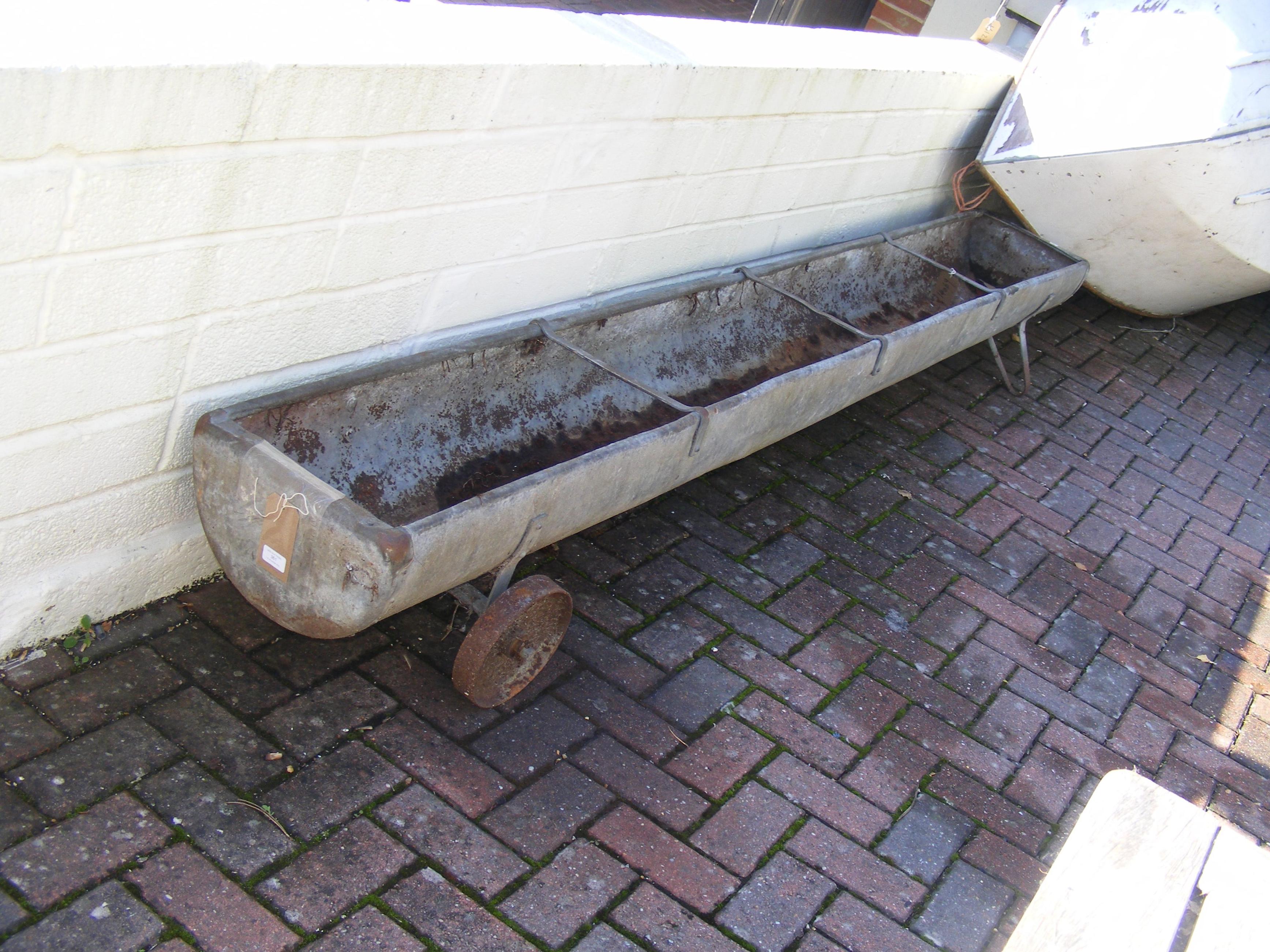 A long galvanized pig trough