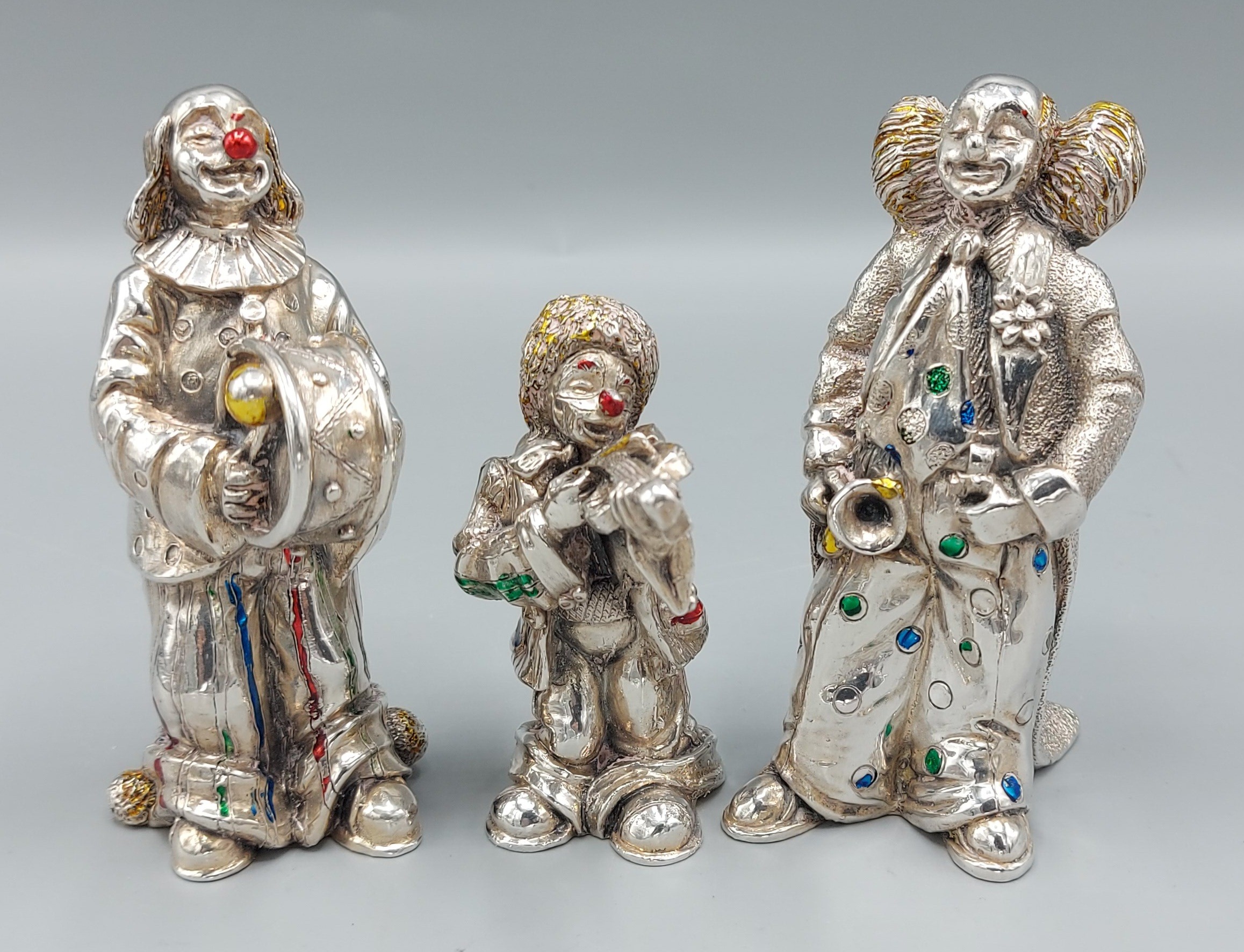 A set of three 925 silver figures in the form of clowns with enamel ...