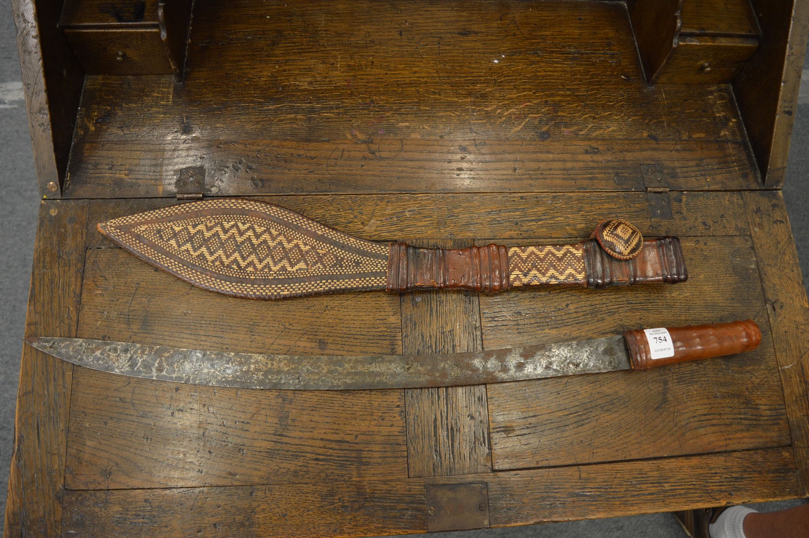 An African sword with decorative leather scabbard.