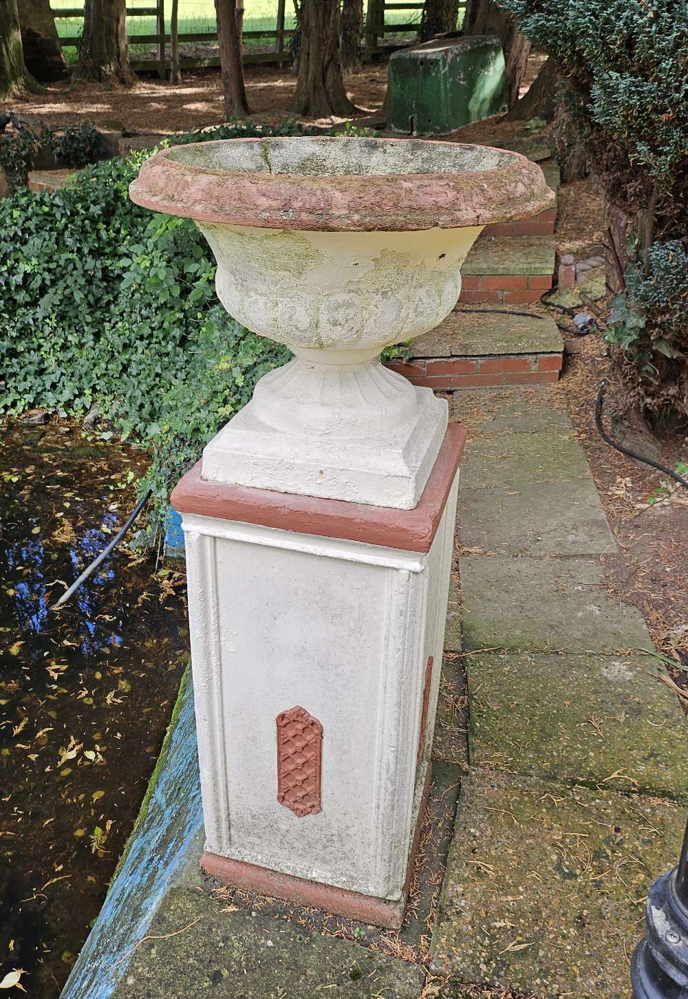 To match 91 - A pair of cast concrete classical garden urns raised over ...