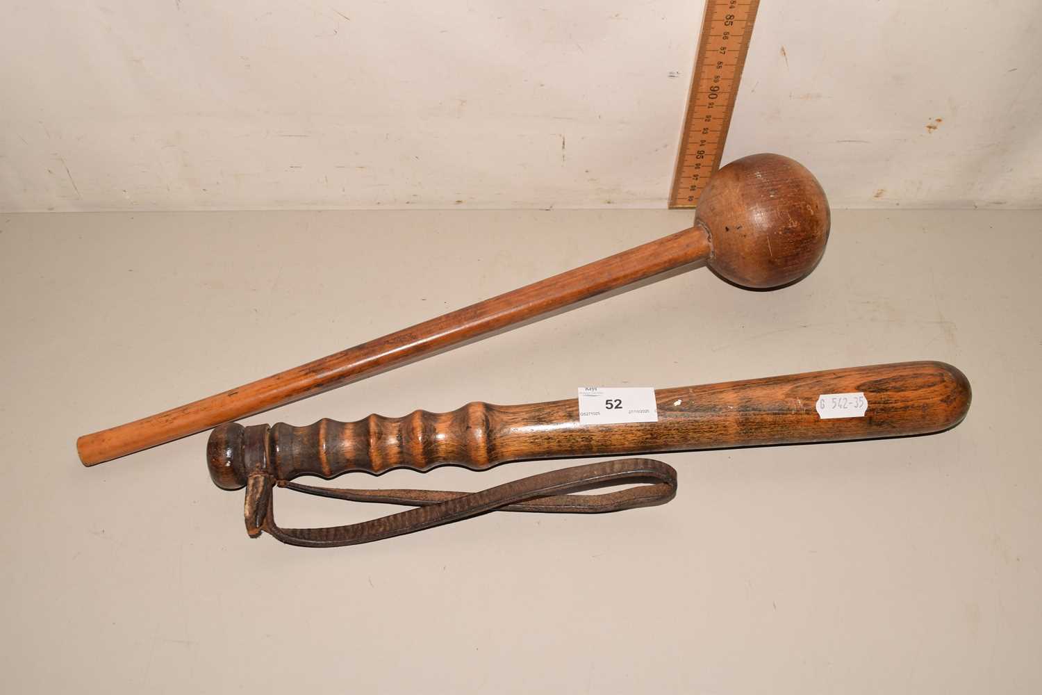 A turned wooded truncheon and a small knobkerri lustre finish jug ...