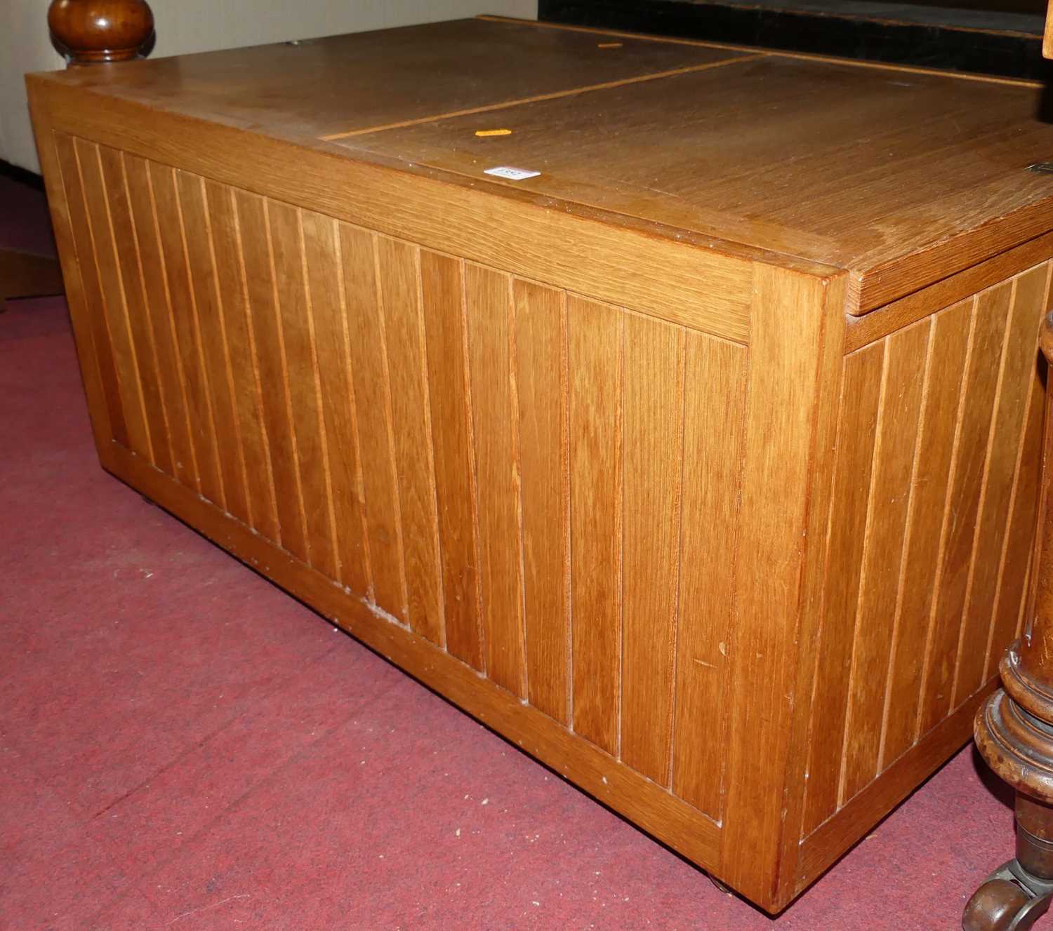 A 1970s teak blanket chest, having opposing pull-out sliding top ...