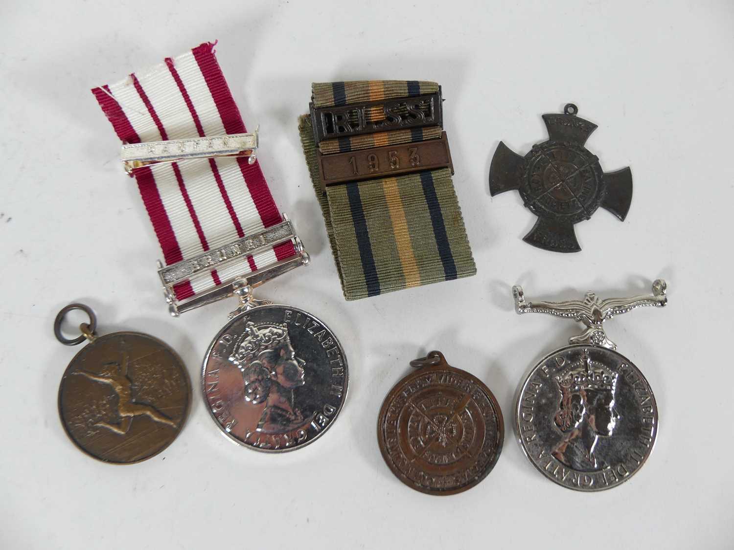 A collection of reproduction military medals and sporting medals