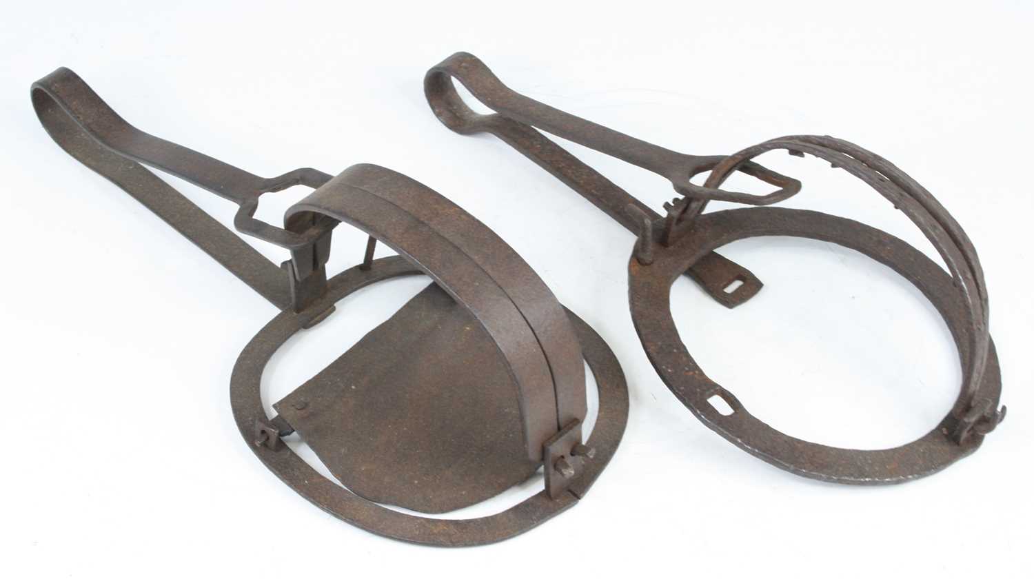 A 19th century iron trap, having 7" rounded serrated jaws, together ...