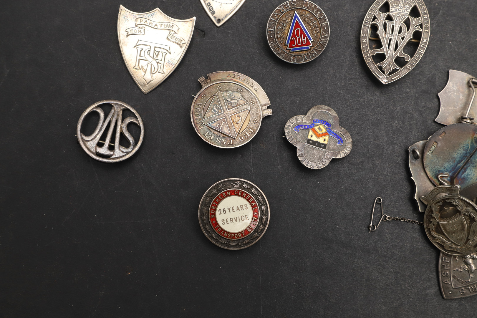 A COLLECTION OF FIFTY SILVER BADGES. A collection of fifty silver ...