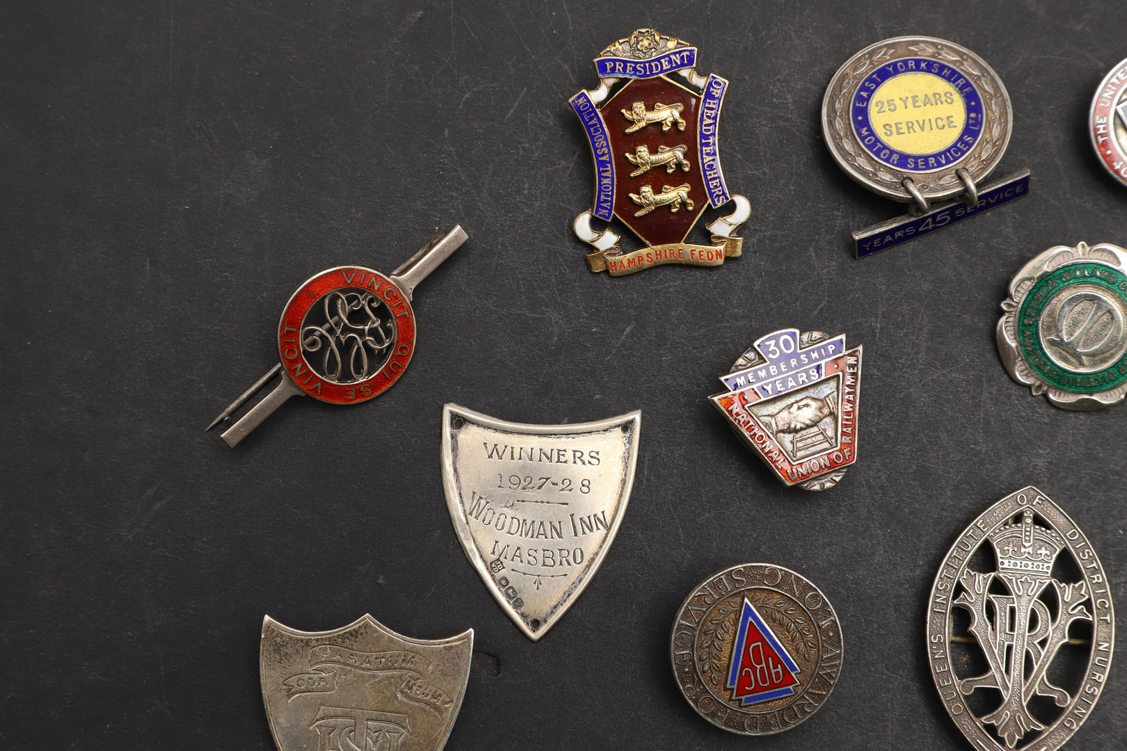 A COLLECTION OF FIFTY SILVER BADGES. A collection of fifty silver ...