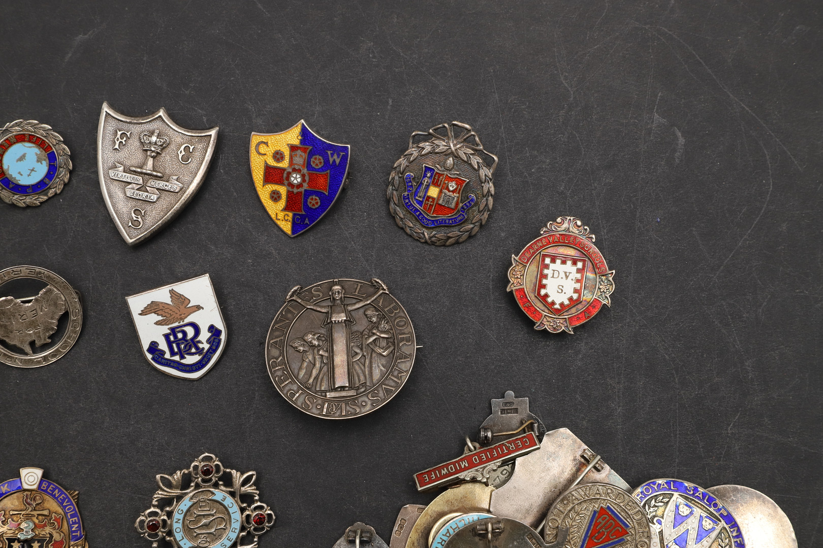 A COLLECTION OF FIFTY SILVER BADGES. A collection of fifty silver ...