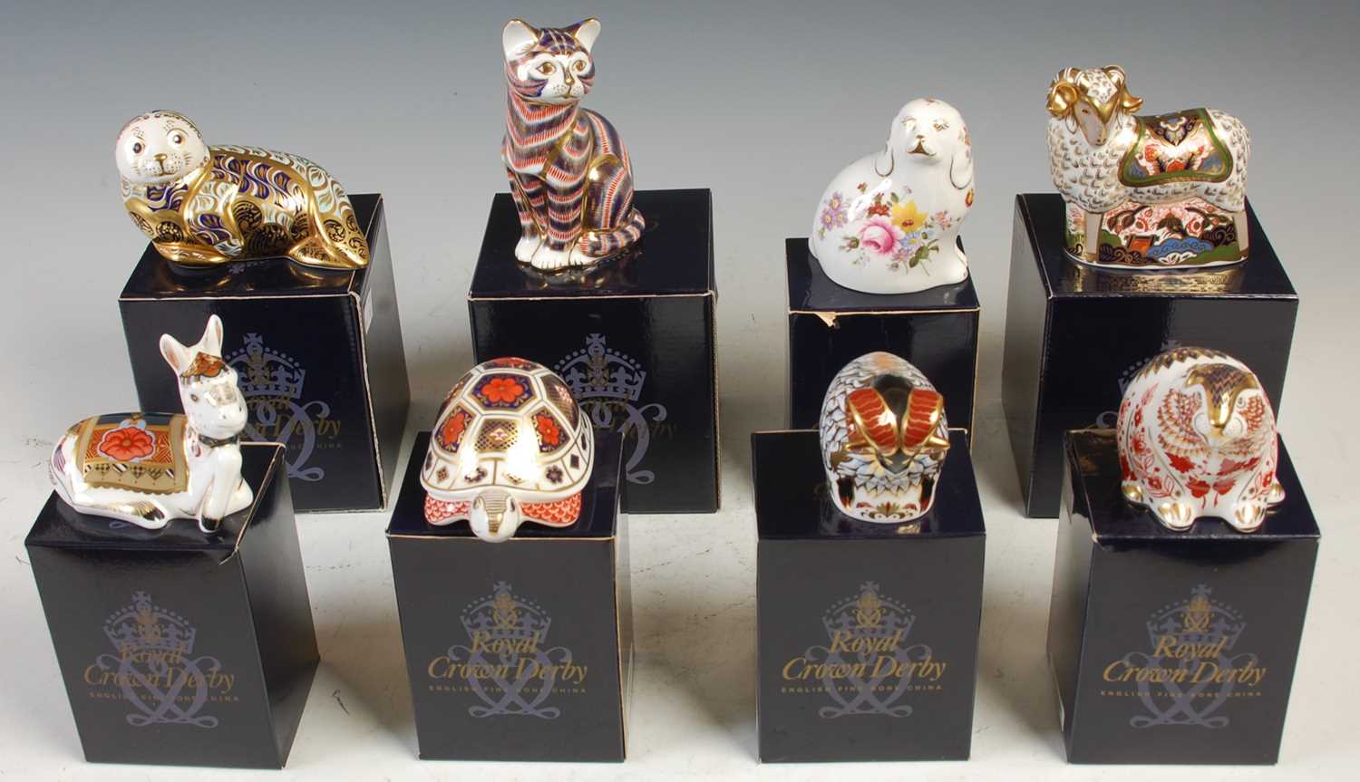 A collection of eight boxed Royal Crown Derby paperweights, to include ...
