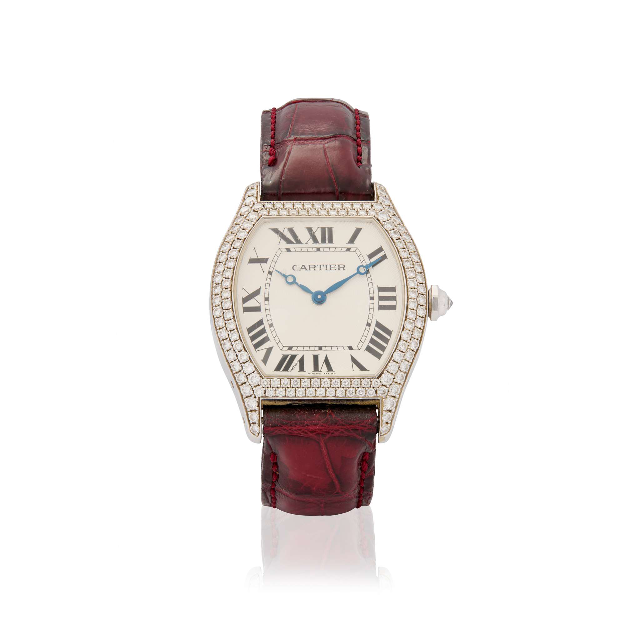 Cartier. A fine 18k white and diamond gold tonneau shape mechanical ...