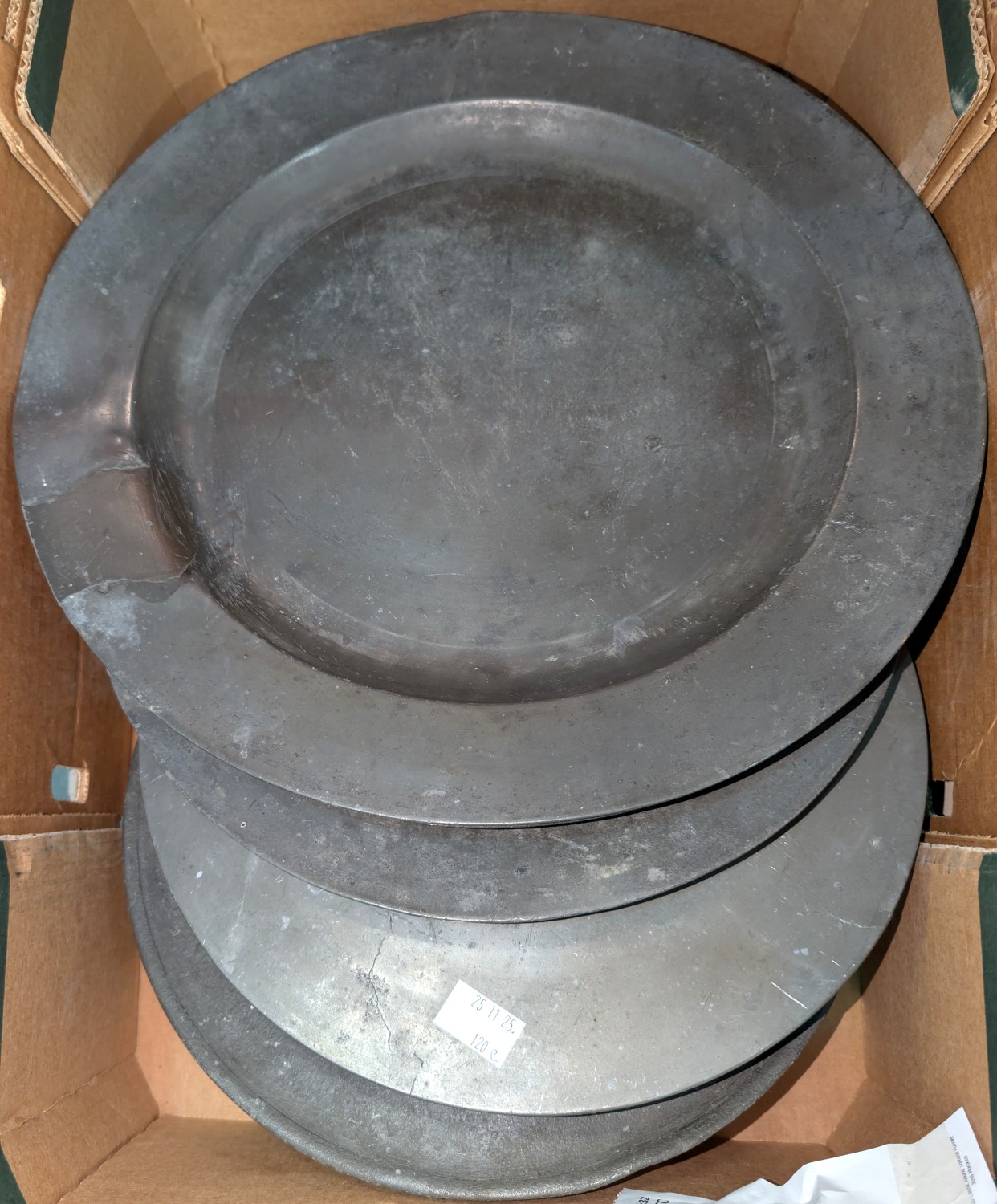A selection of pewter chargers, up to 42cm.