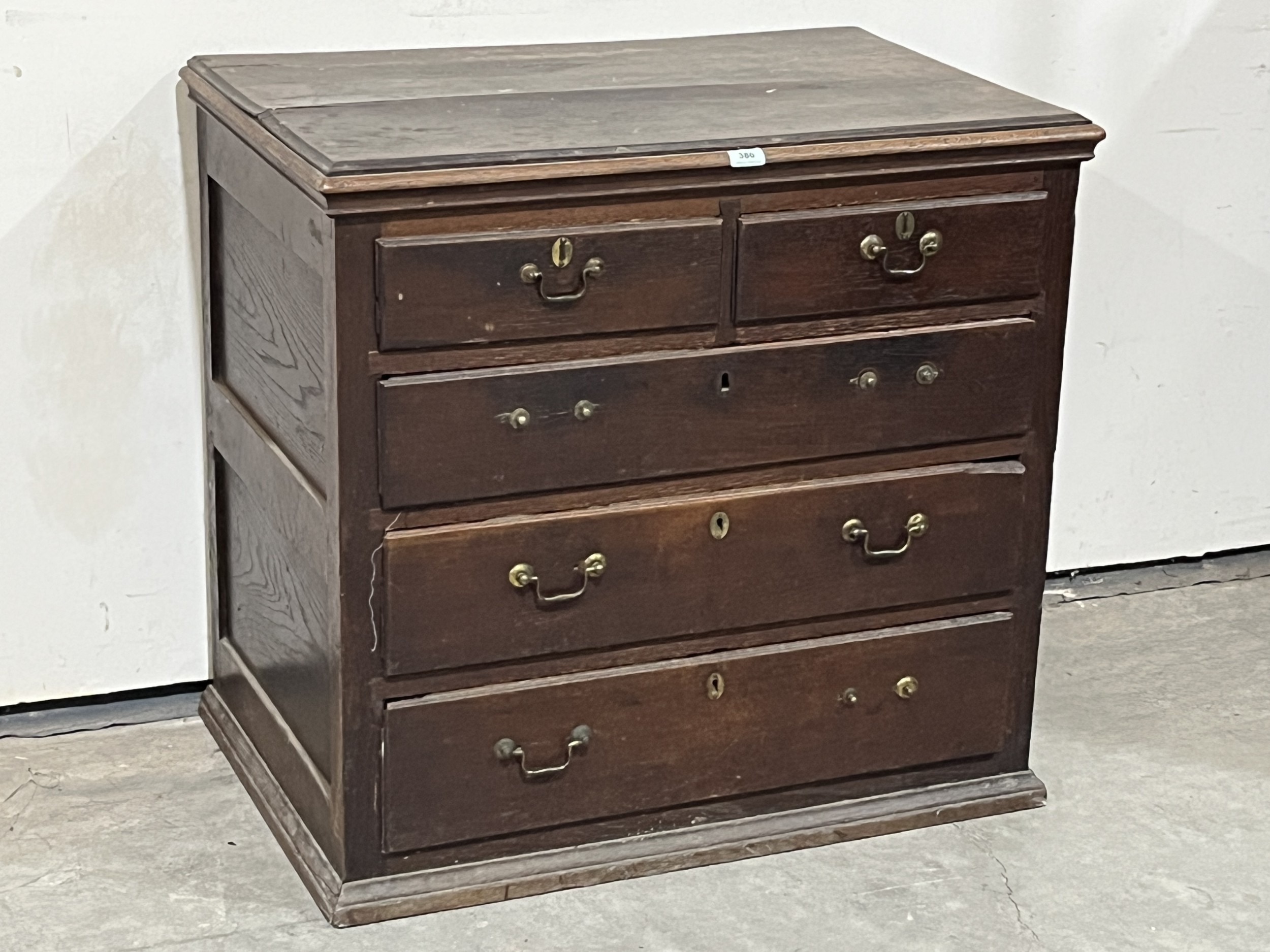 An early 18th century joined oak chest of drawers, the sides panelled ...