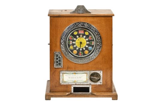 Mechanical gaming. An oak cased slot machine, c1950s, fruit dial ...
