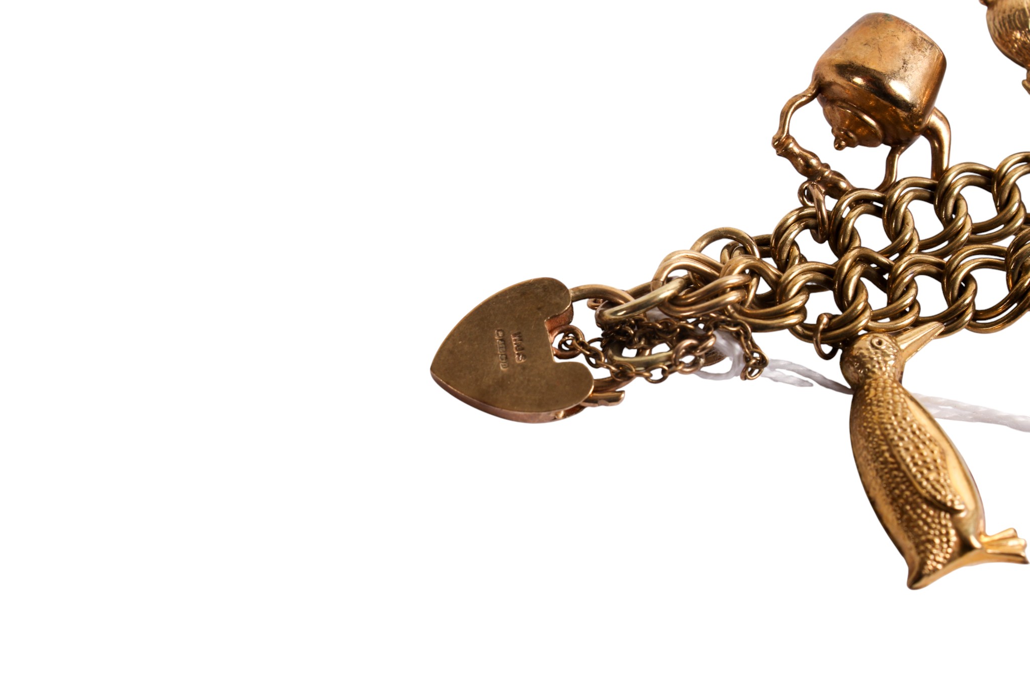 A 9ct gold charm bracelet with a pendant 1911 half sovereign coin. All ...