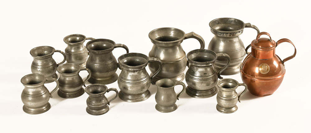 A collection of antique pewter measures (12), and a small copper milk ...