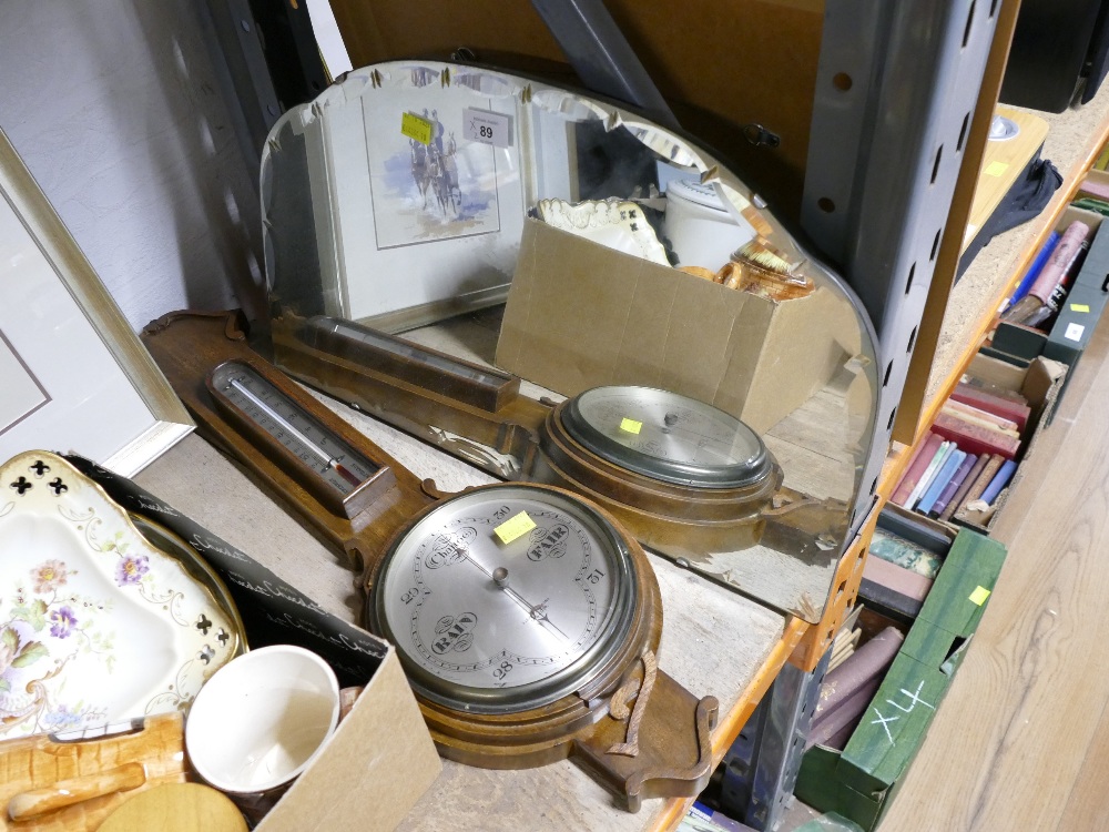 Small frameless mirror and a barometer