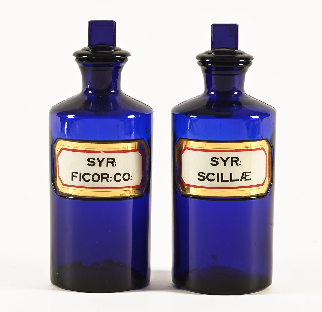 A pair of Victorian blue glass chemists bottles, each with stopper and ...