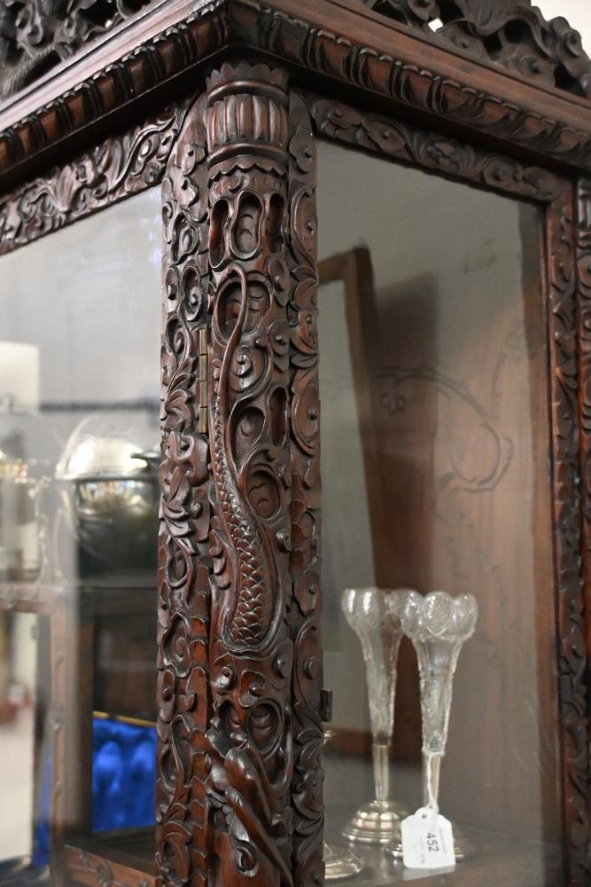A late 19th century Chinese hardwood display cabinet, with dragon ...