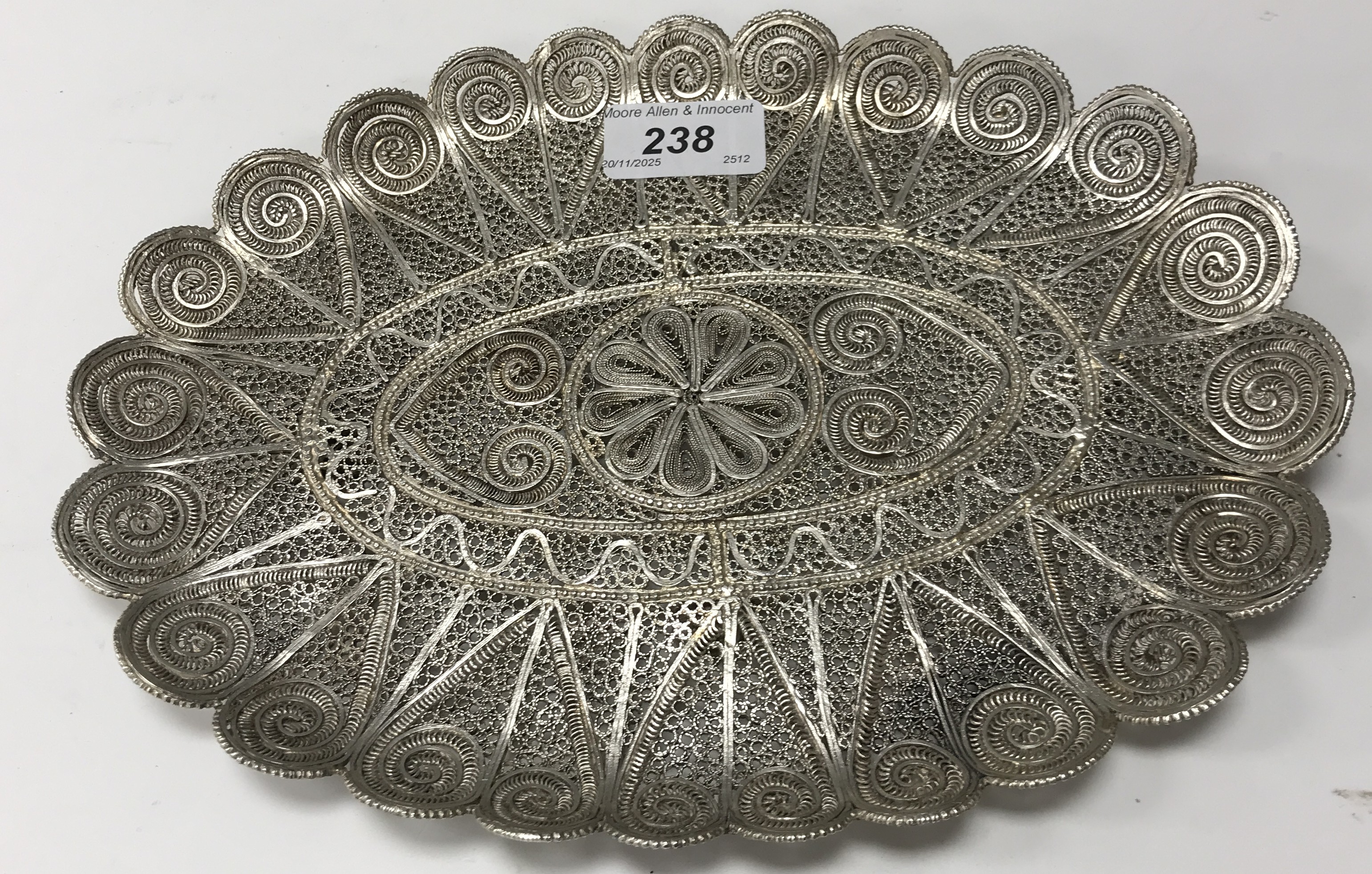 A Continental white metal filigree work oval dish with all over foliate ...