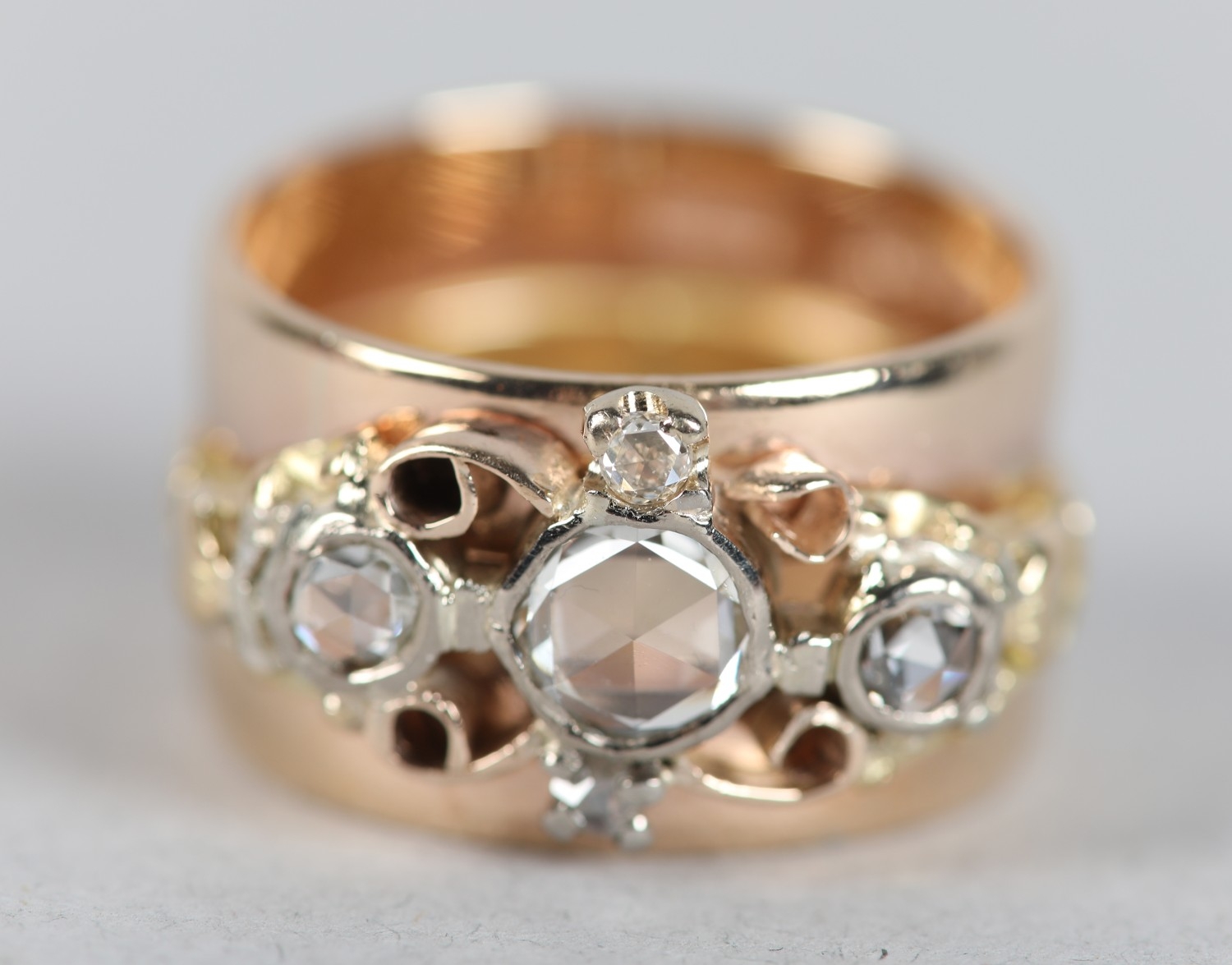 A DIAMOND RING, collet set with five graduated 17th century rose cut ...
