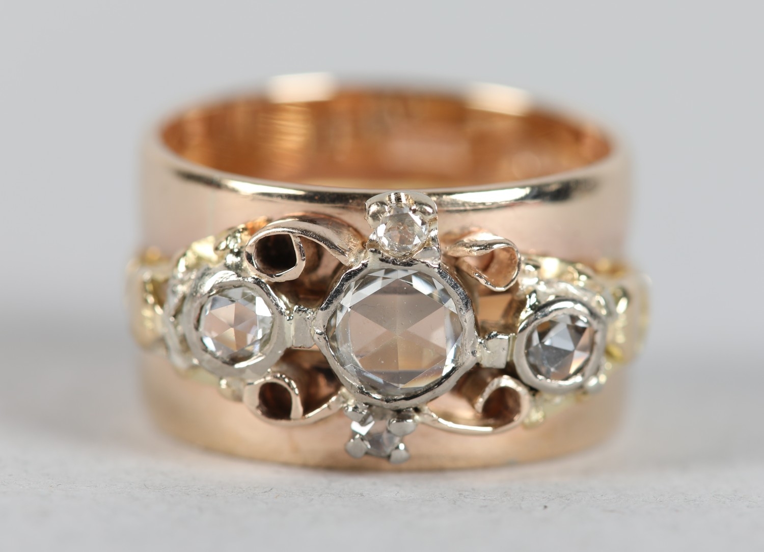 A DIAMOND RING, collet set with five graduated 17th century rose cut ...