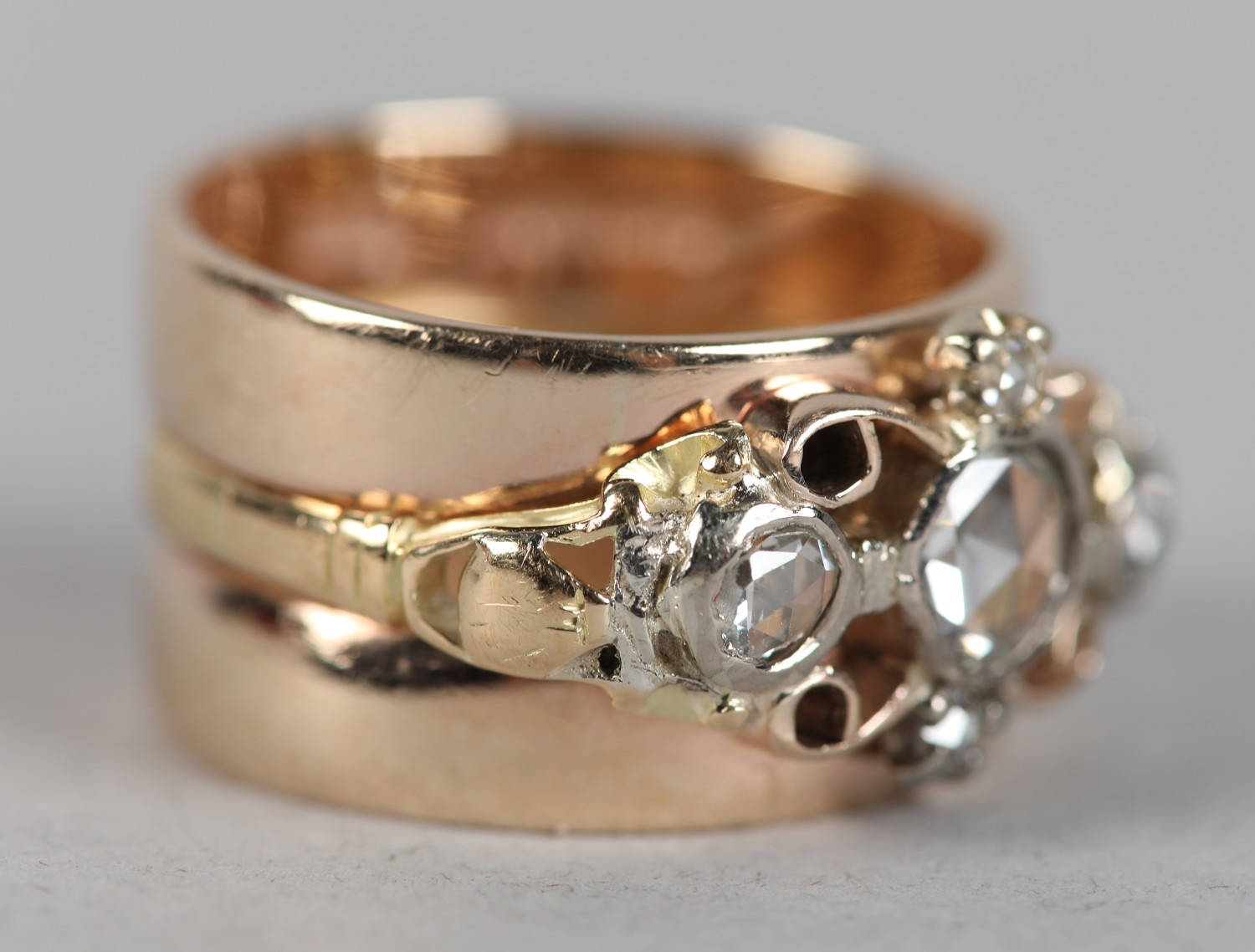 A DIAMOND RING, collet set with five graduated 17th century rose cut ...