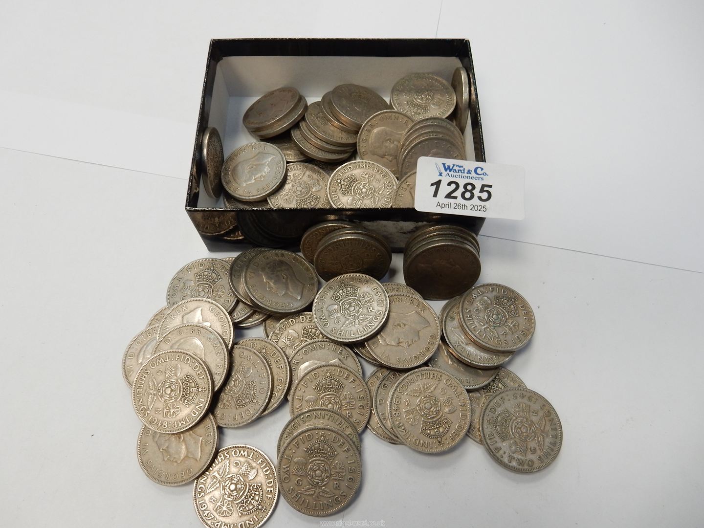 A box of two shilling coins.
