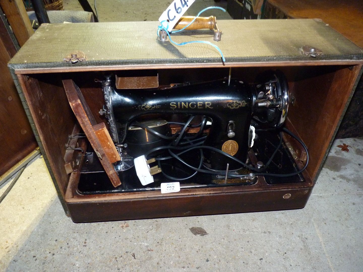 An electric Singer sewing machine, cased.