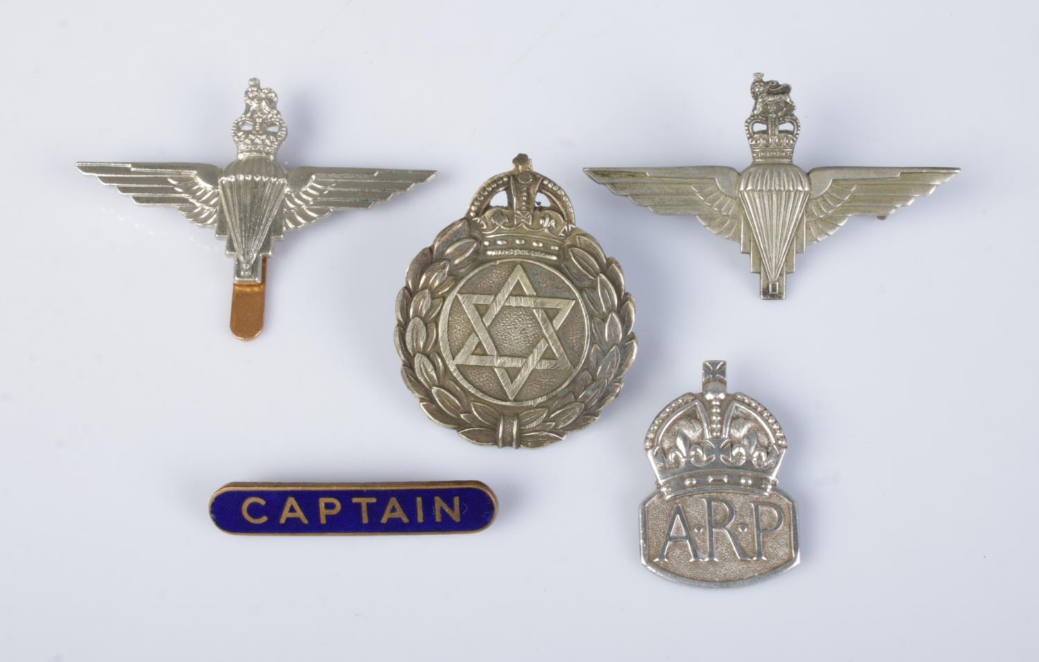Five military badges, to include silver ARP badge (London, 1938 ...